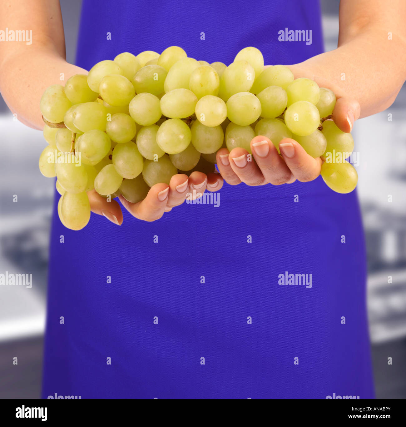 WOMAN WITH HANDFUL OF GREEN GRAPES Stock Photo - Alamy