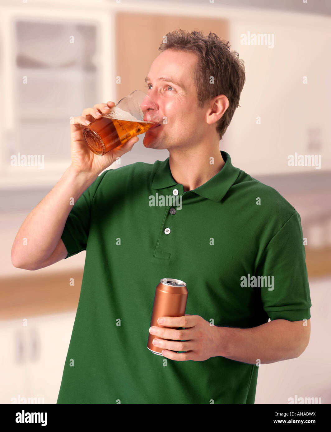 MAN IN KITCHEN DRINKING ALE Stock Photo - Alamy