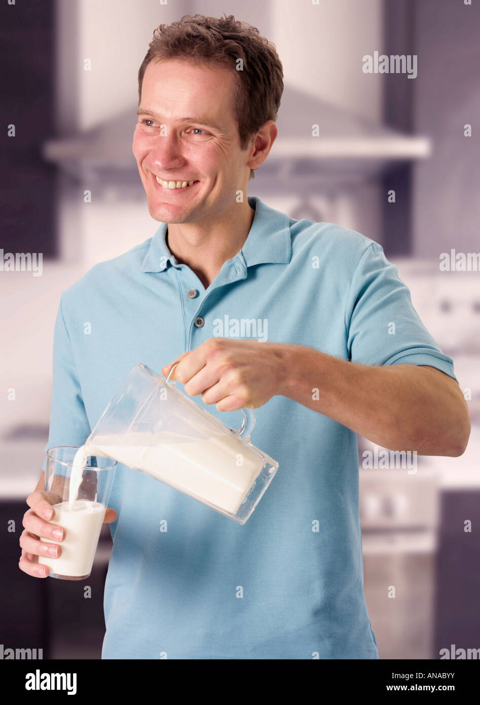 MAN IN KITCHEN POURING MILK Stock Photo - Alamy