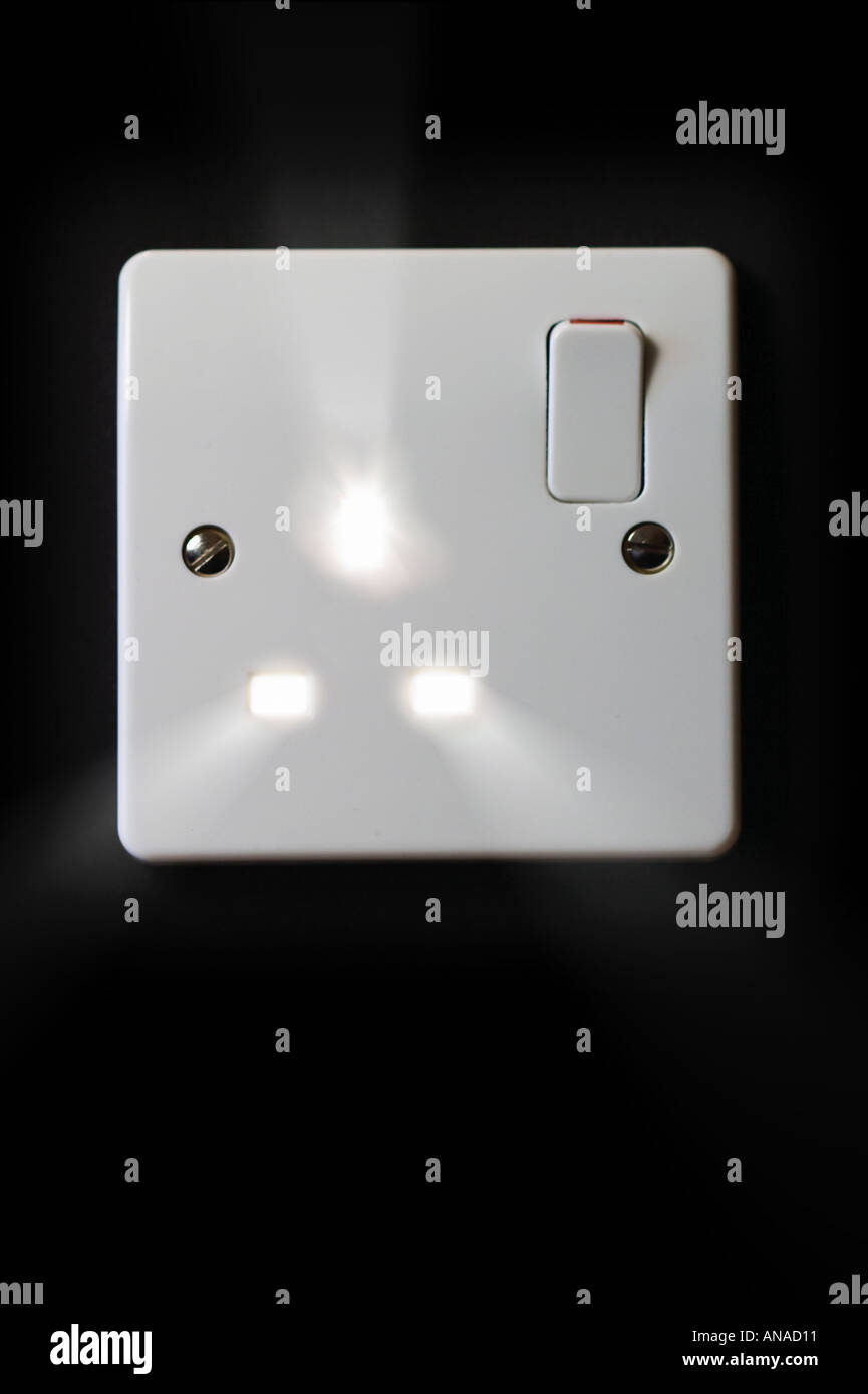 UK Electrical Power Outlet with light shining from socket holes Stock ...