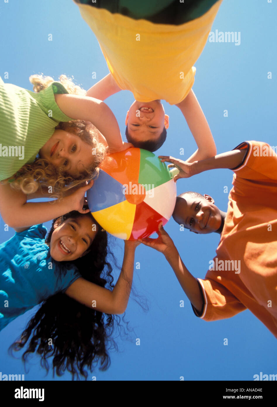 Children from below with ball Stock Photo - Alamy