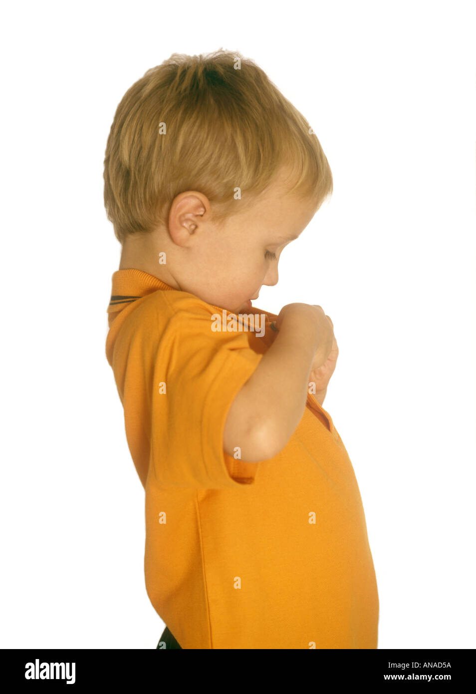 Young boy learning to dress himself Stock Photo - Alamy