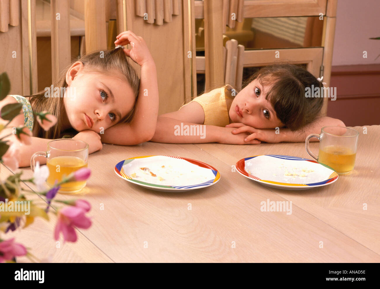 Children 2 girls full after meal Stock Photo - Alamy