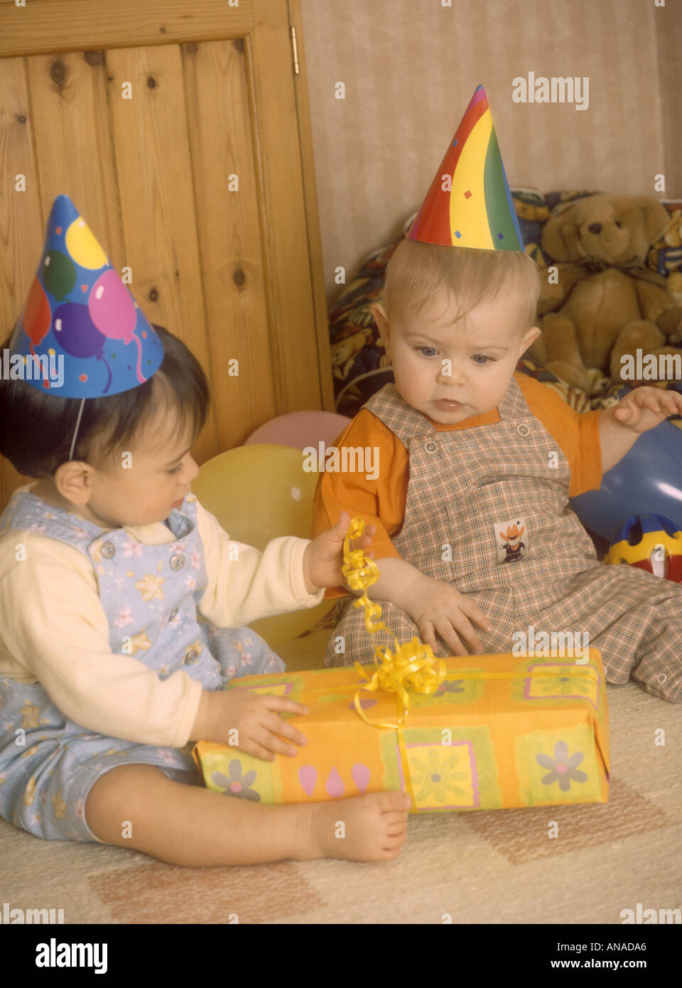 Boy unwrapping presents at his birthday party hi-res stock photography ...