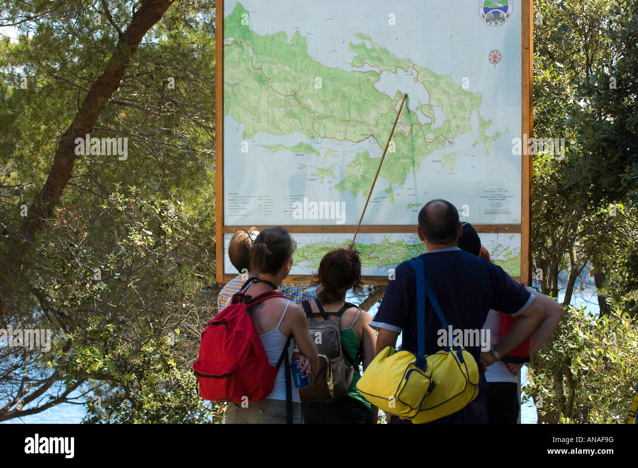 Pointing to location on tourist map Stock Photo - Alamy