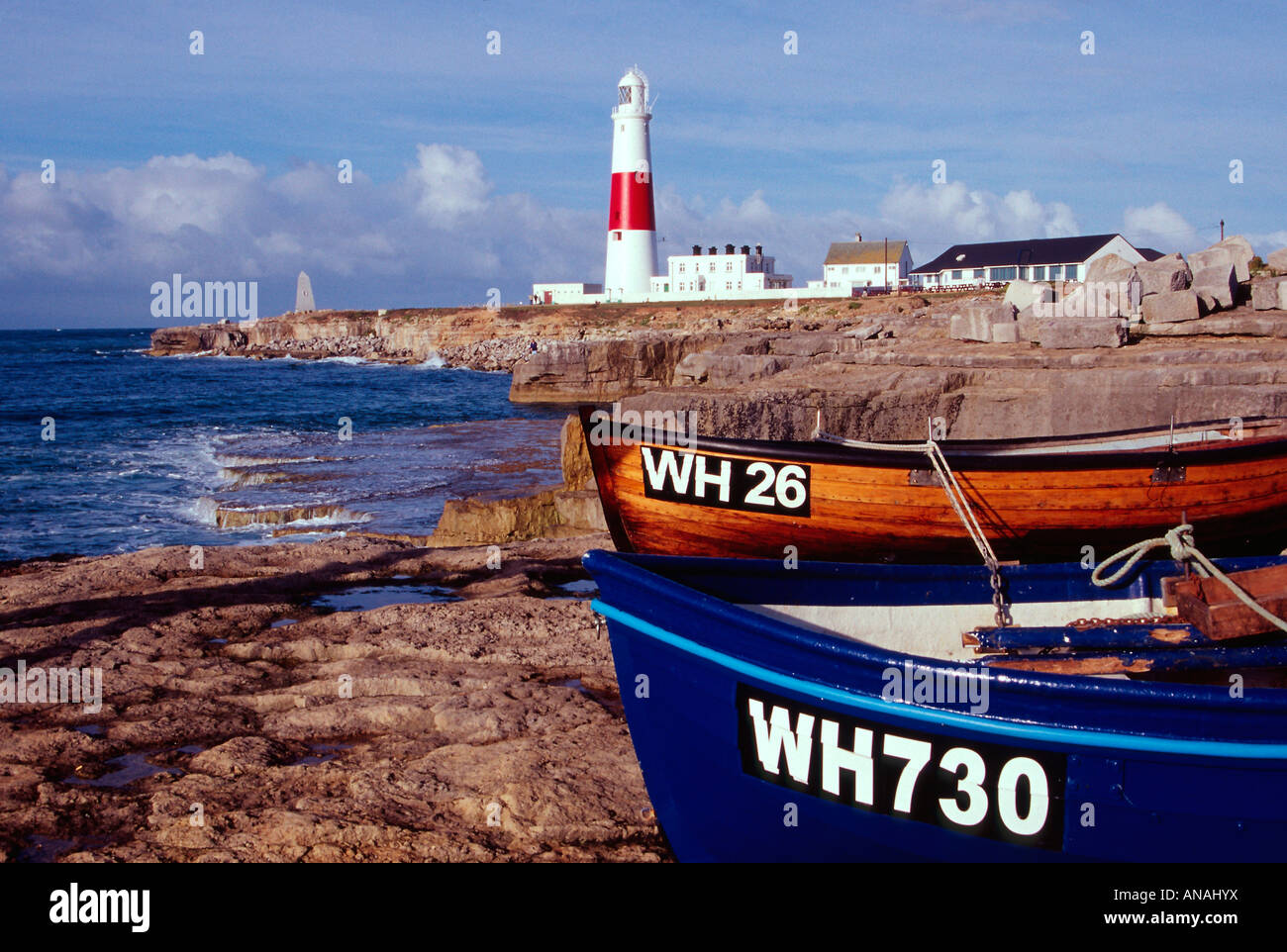 portland bill lighthouse and fishing boat waves on cliff s dorset ...