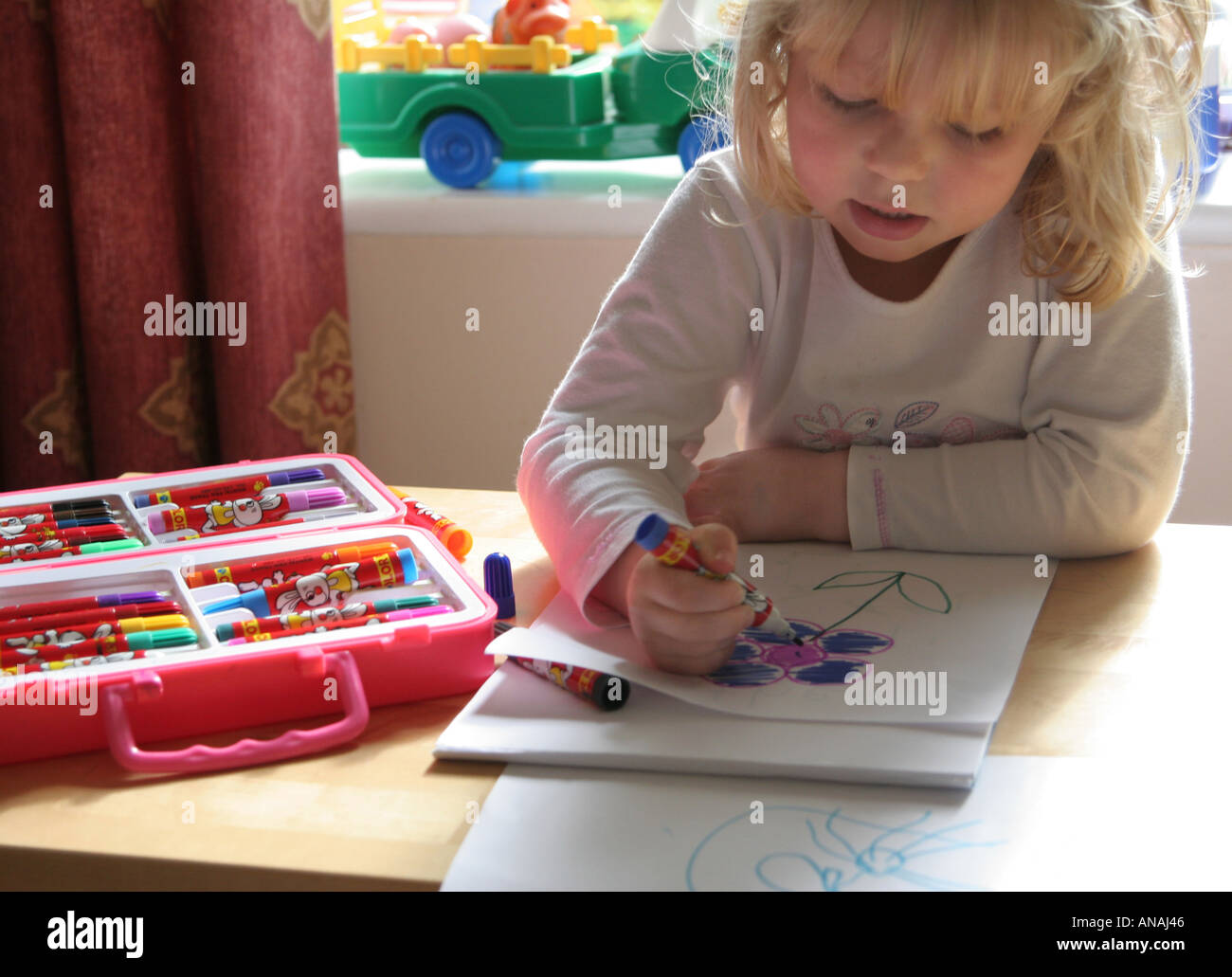 young girl with colouring book Stock Photo - Alamy
