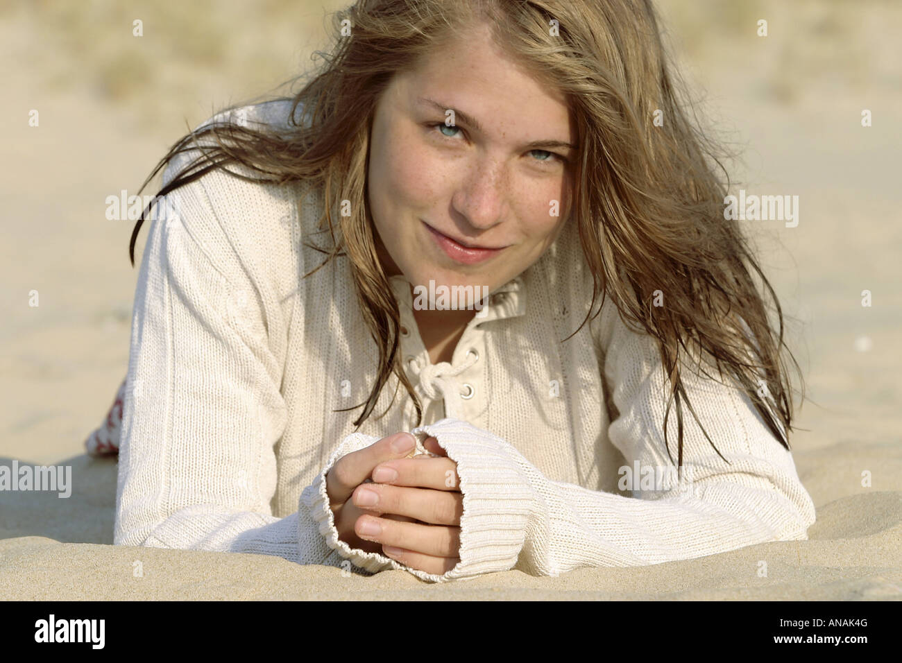 joung woman lying in the sand Stock Photo - Alamy