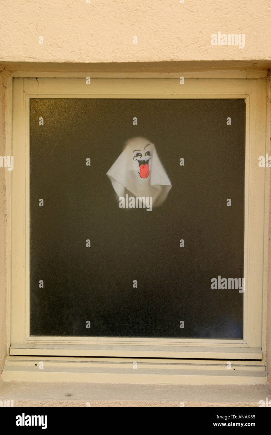 Toy ghost peering through translucent window in Bayeux France Stock ...