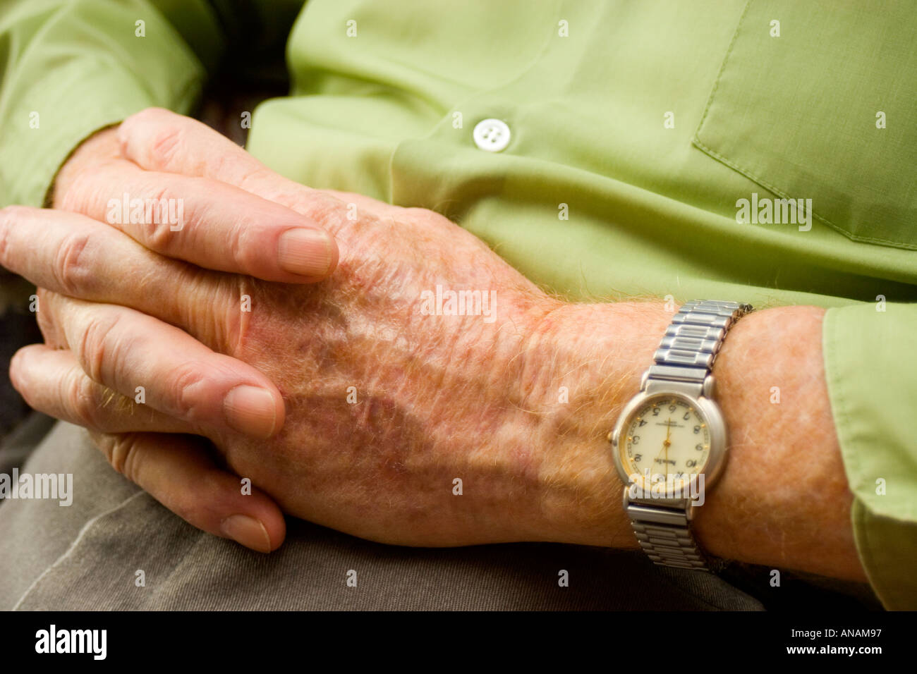 Retired man with hands folded Stock Photo - Alamy