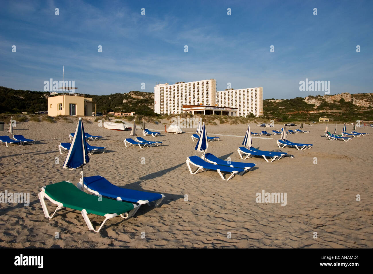 Beach loungers and hotels Son Bou beach south coast Menorca Stock Photo ...