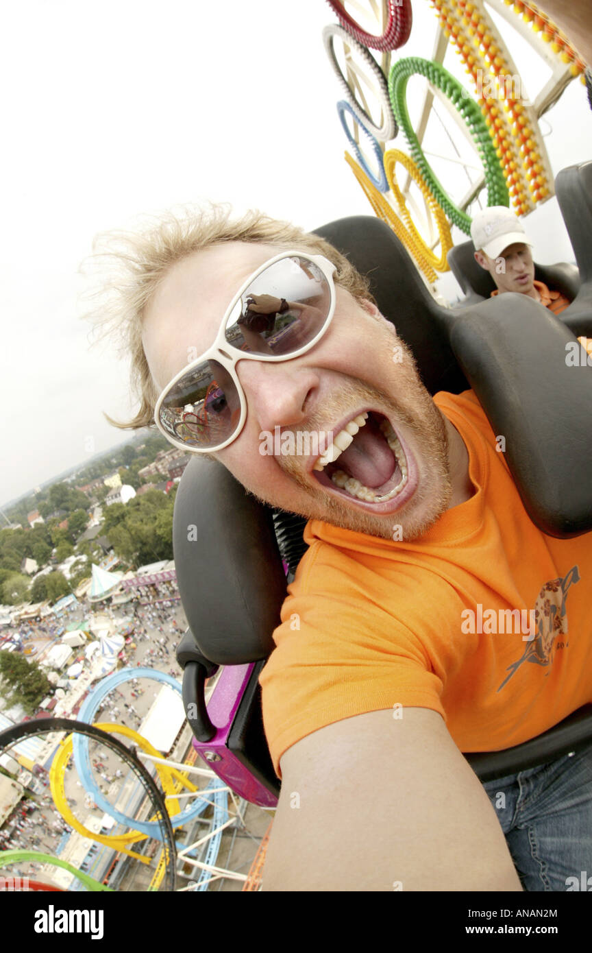 Crazy young man on the crange fun fair hi-res stock photography and ...