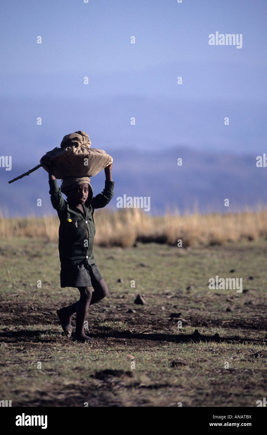 Young boy carrying food in the highlands Ethiopia Stock Photo - Alamy