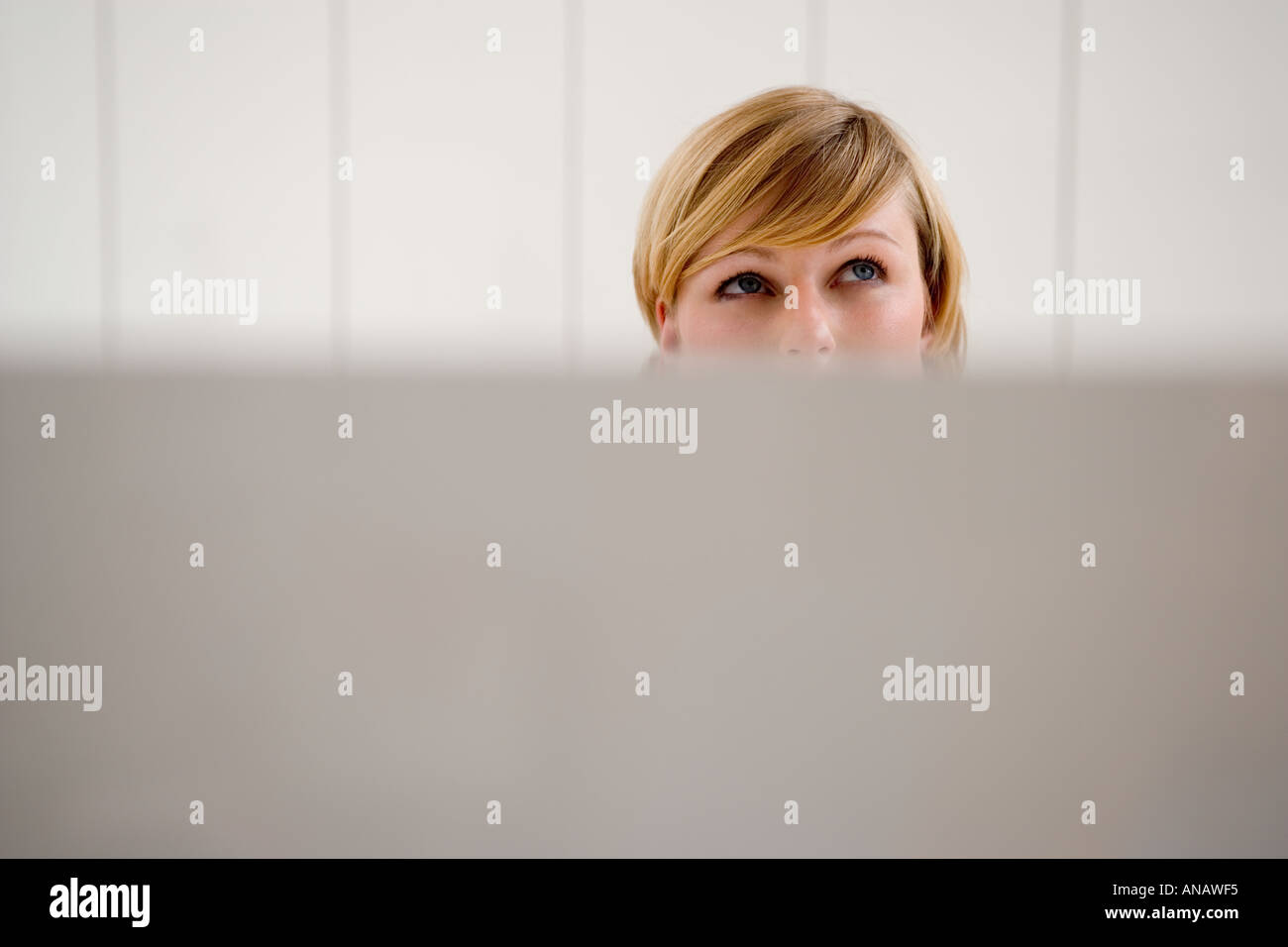 woman looking up from behind her desk Stock Photo - Alamy