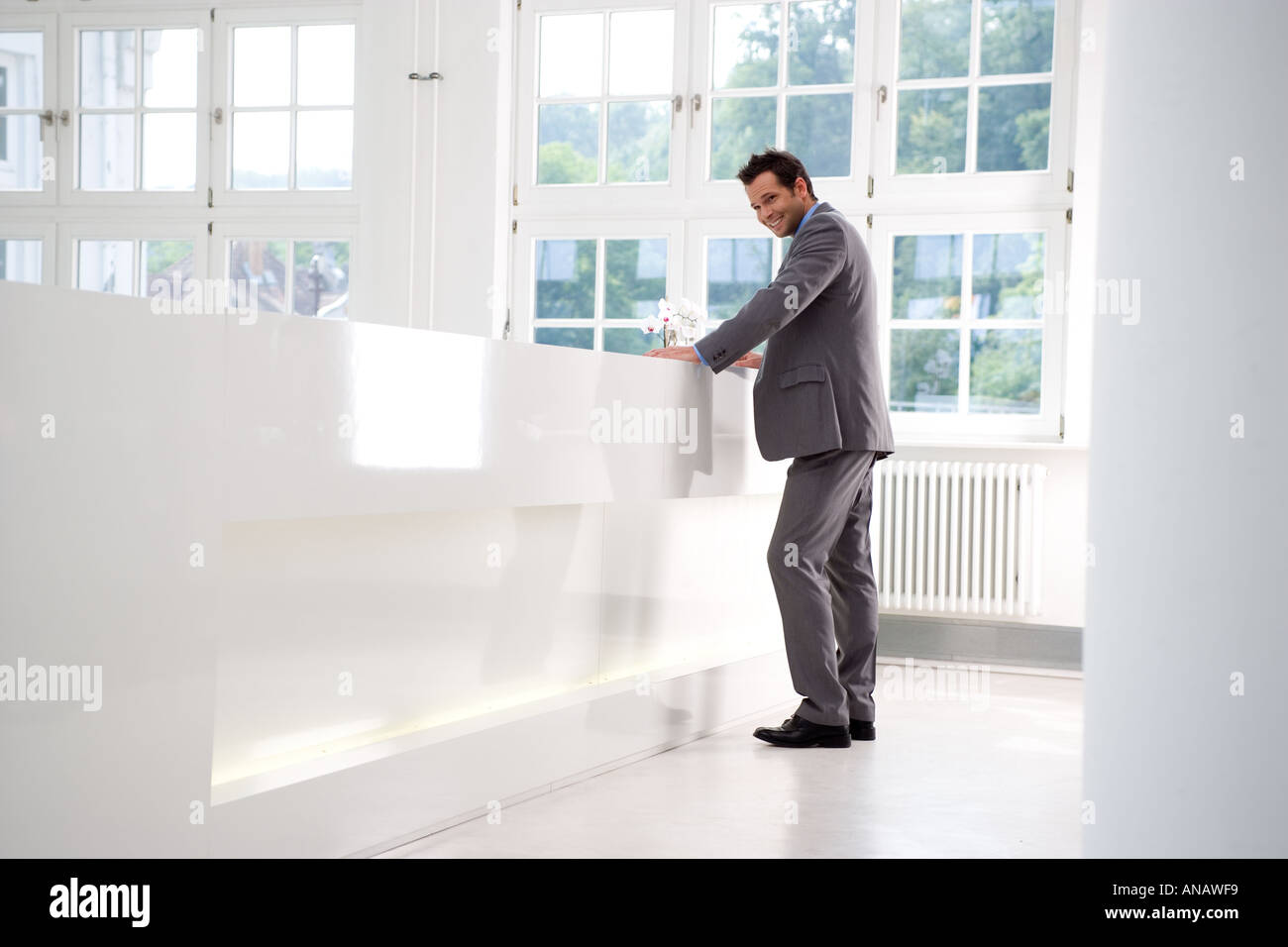 businessman standing at reception desk in lobby Stock Photo - Alamy
