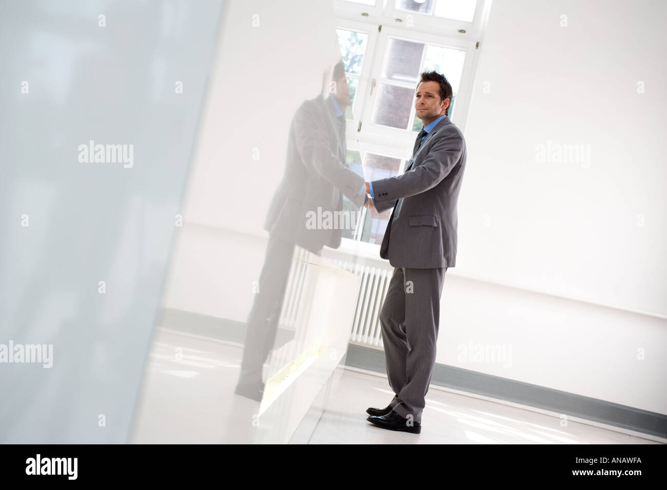 young businessman waiting at reception in office building lobby Stock ...