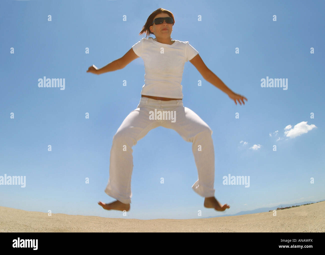 young woman cutting a caper at the beach Stock Photo - Alamy