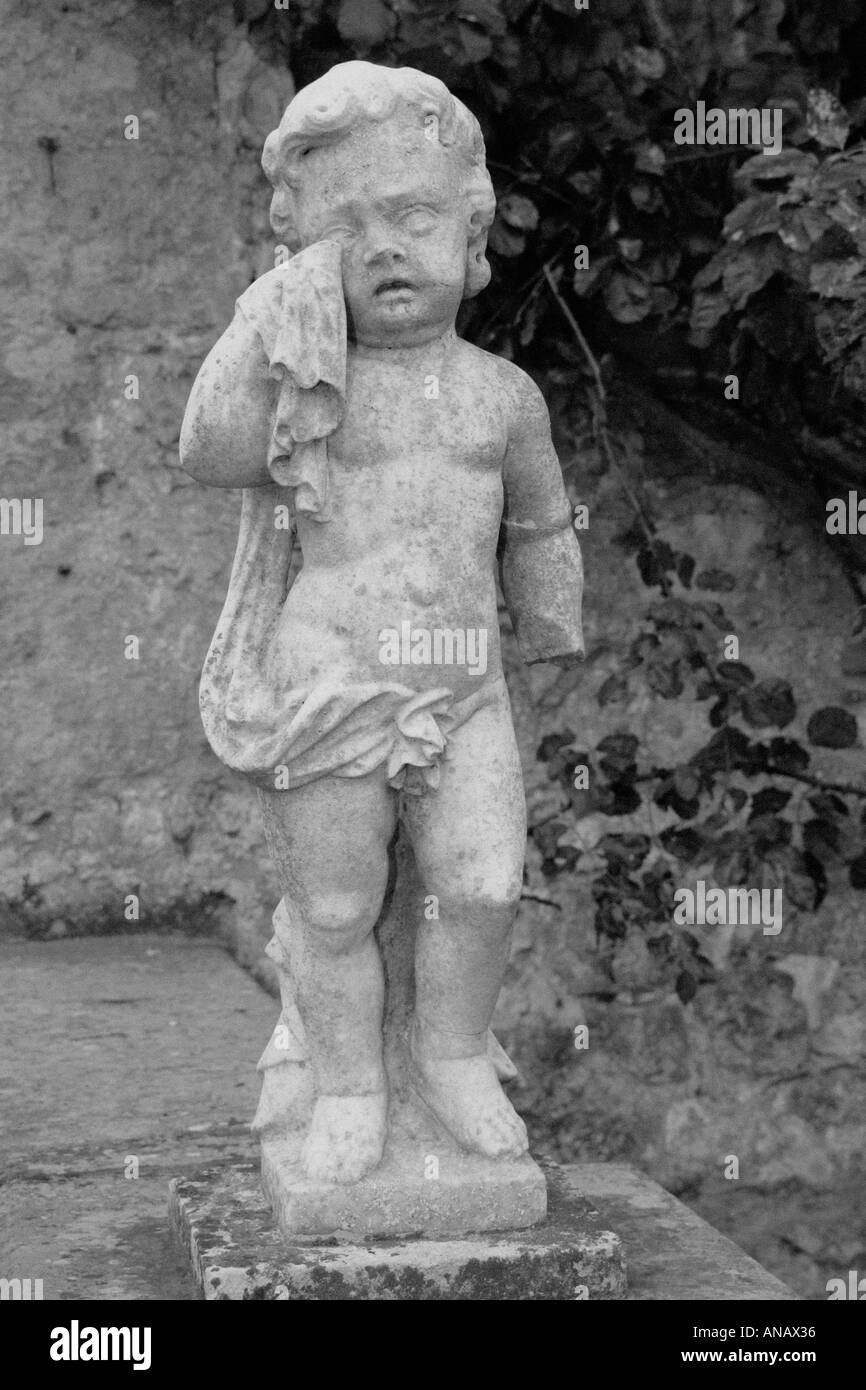 Old stone statue of a crying child Stock Photo - Alamy