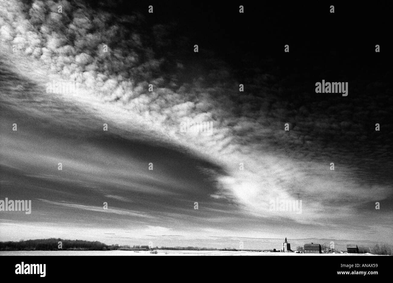 Canada. Barns on a dramatic and atmospheric Prairie skyline at dusk ...
