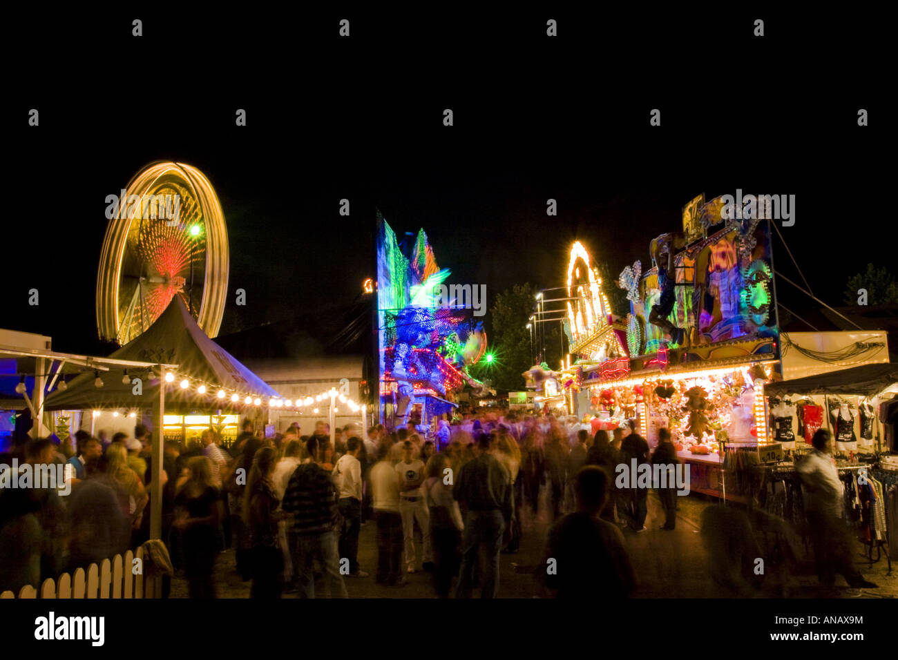 fun fair in the evening, crowd and big wheel, Germany, Baden ...