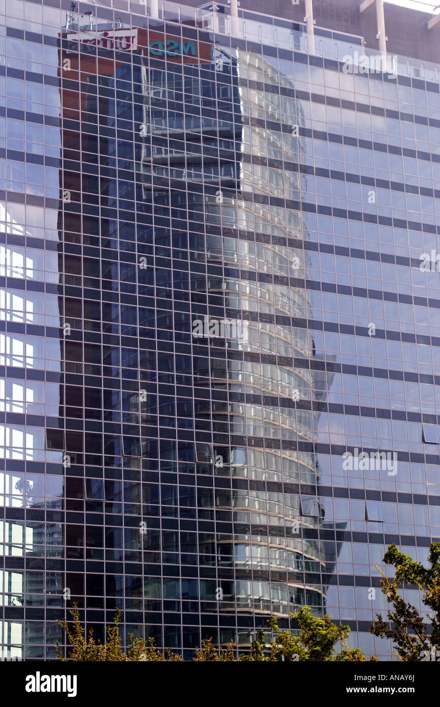 modern high-rise building in Donau City, mirroring on a glass cladding ...