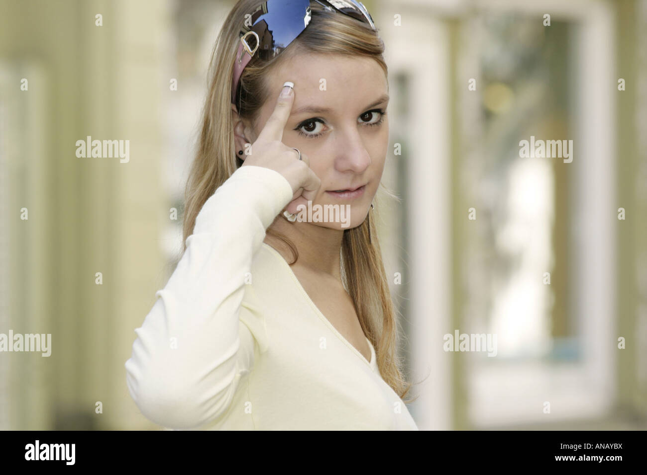 pretty blond woman with a impudent gesture Stock Photo - Alamy