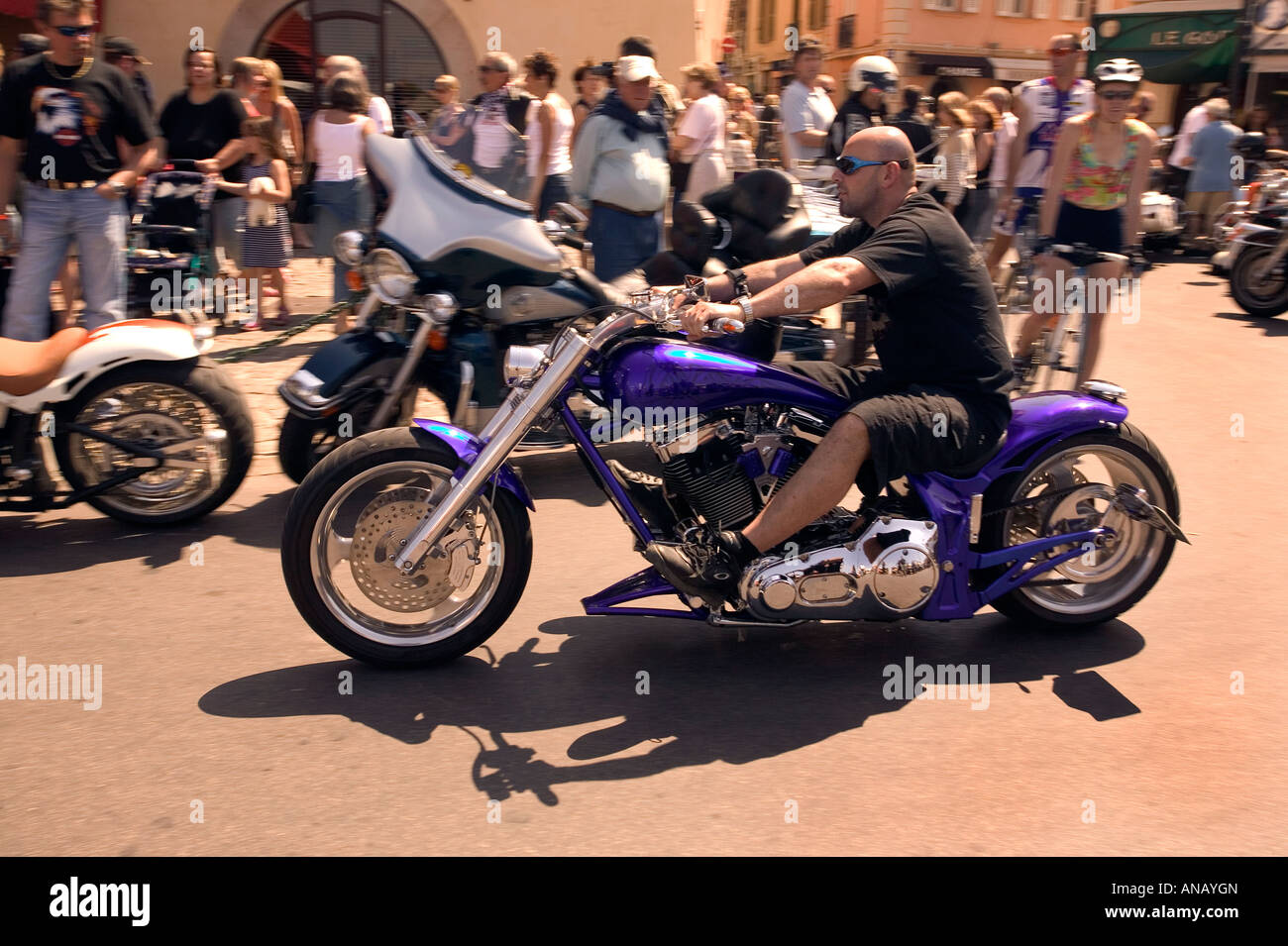 Biker riding through strets of St Tropez France Stock Photo - Alamy