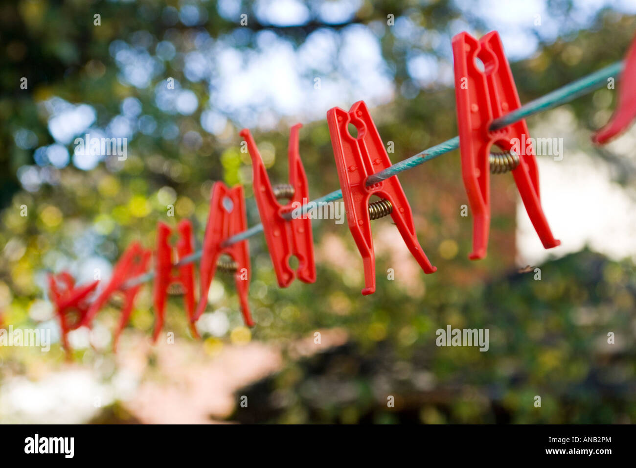 Red clothes pegs on a washing line Stock Photo - Alamy