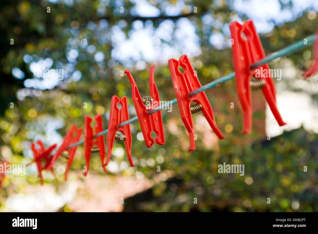 Red plastic clothes pegs on a washing line Stock Photo - Alamy