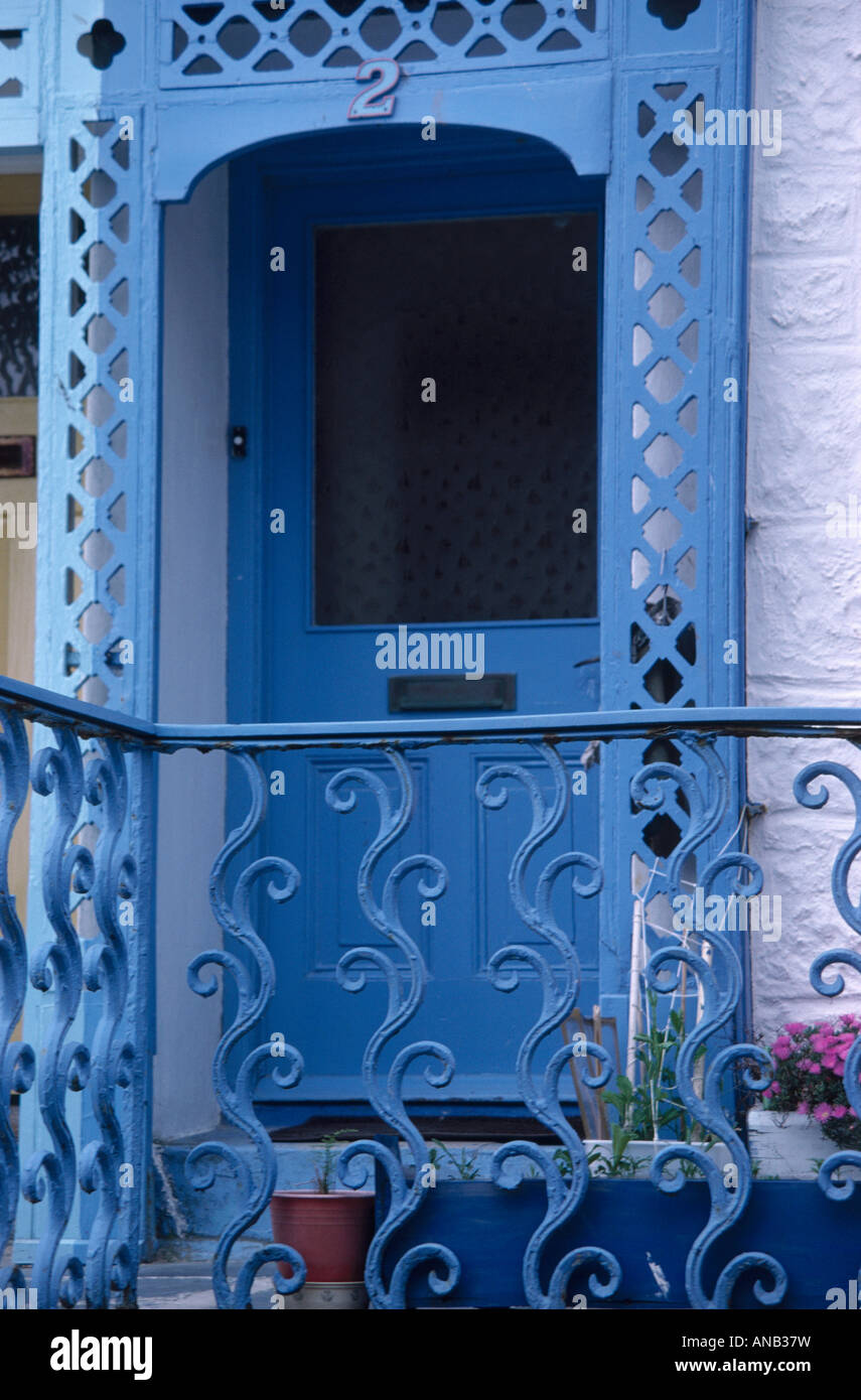 Ornate blue railings in front of blue door with blue fretwork porch ...