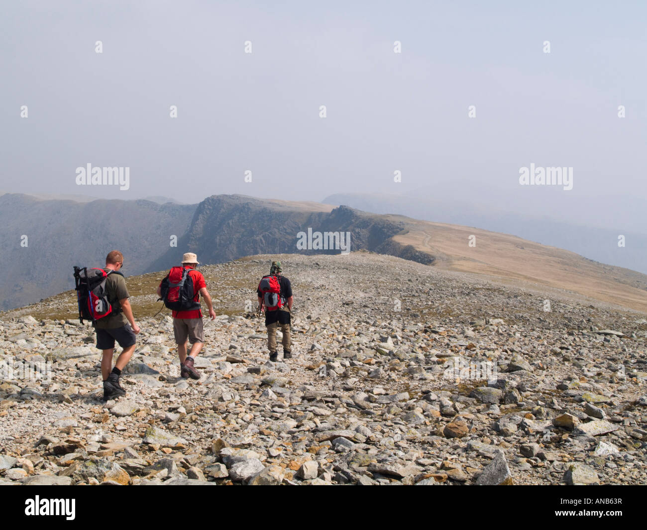 People walking rocky path on descent from Carnedd Dafydd mountain to ...