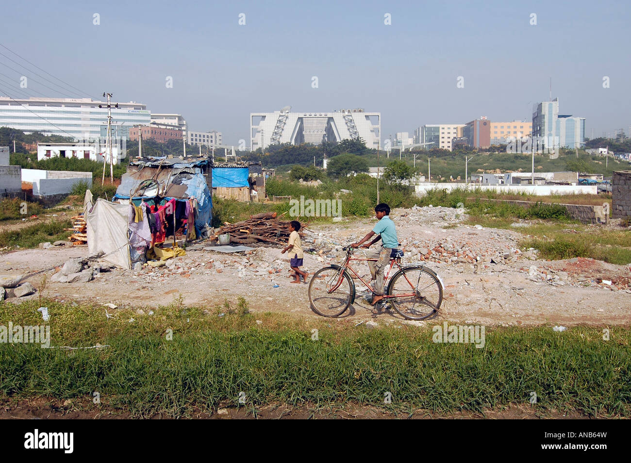 An Indian kid doing bicycle in a slum located right in the middle of ...