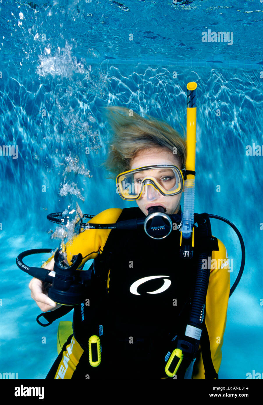 Woman diver demonstrates regulator clearing technique Stock Photo - Alamy