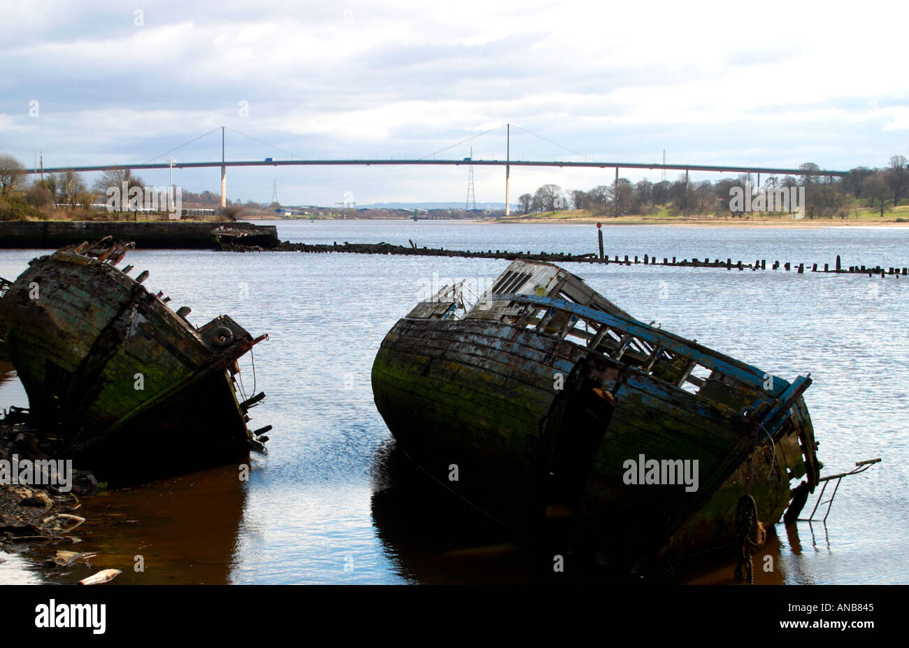 Wrecked boats in River Clyde with modern bridge in background Stock ...