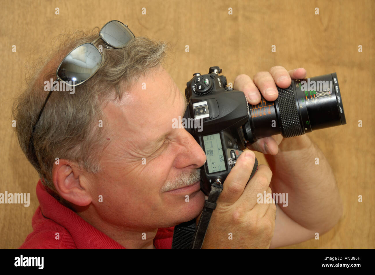 A professional photographer tests a brand new digital SLR camera with a ...