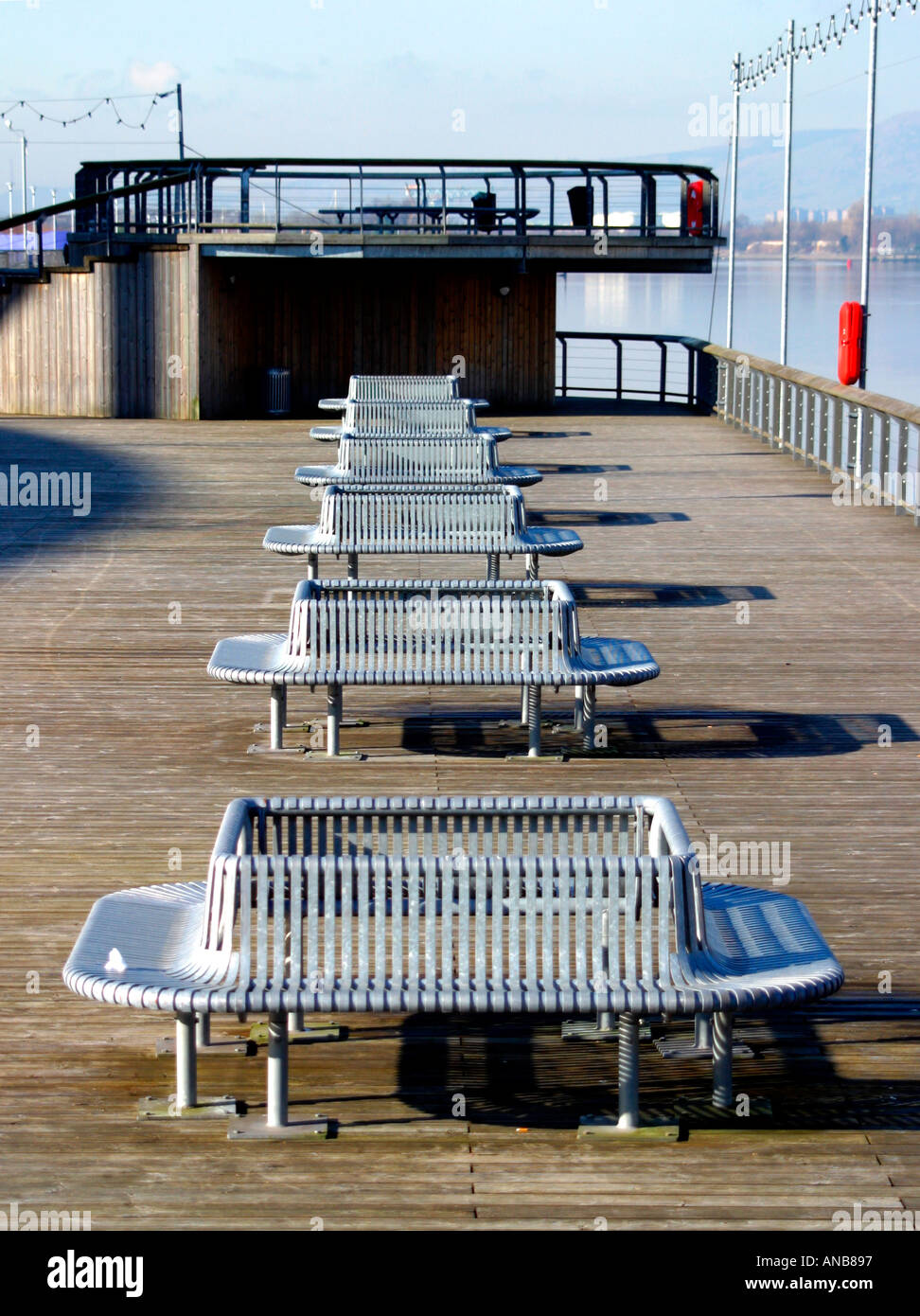 Deserted seats on riverside boardwalk Stock Photo - Alamy