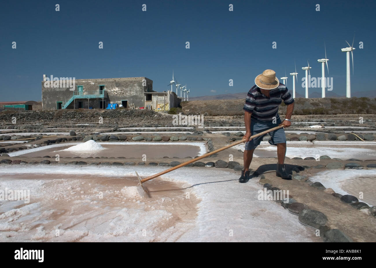 Spanish man in his seventies raking salt at Las Salinas (saltworks ...