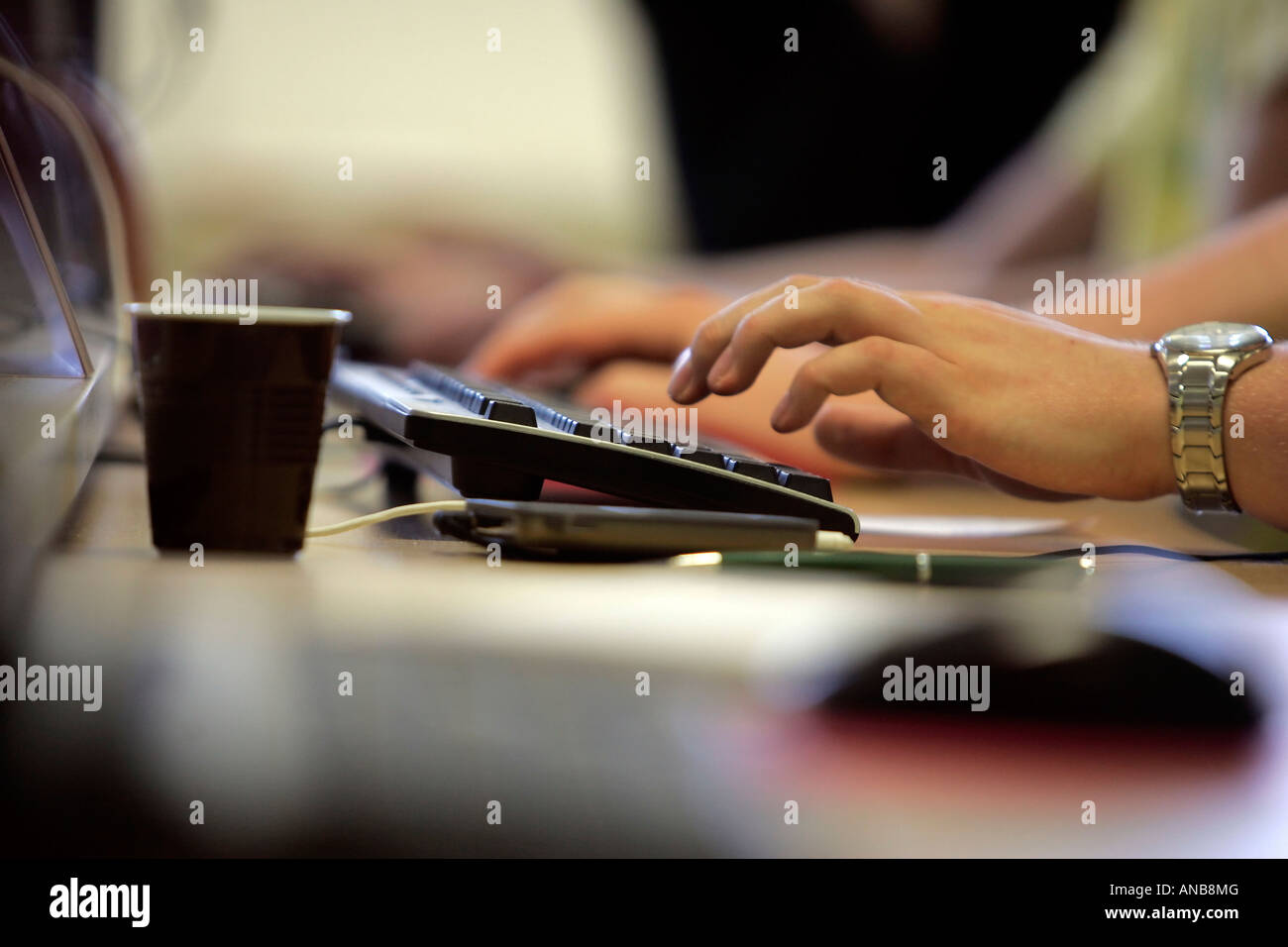 CLOSE-UP OF AN FEMALE OFFICE WORKER'S HANDS USING A COMPUTER KEYBOARD ...