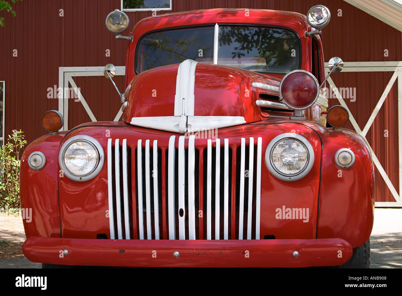Antique fire engine in front of a red barn Stock Photo - Alamy
