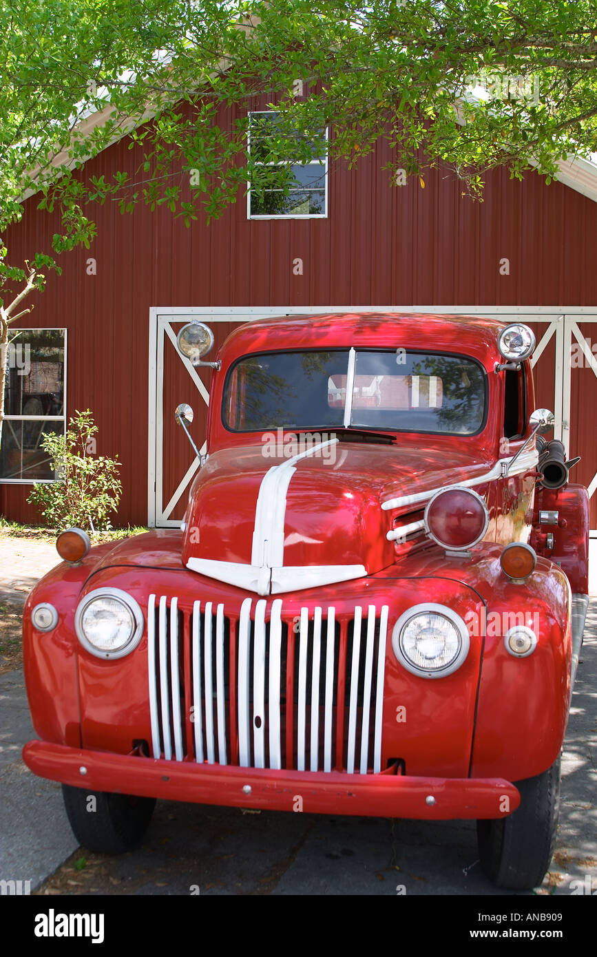 Antique fire engine in front of a red barn Stock Photo - Alamy