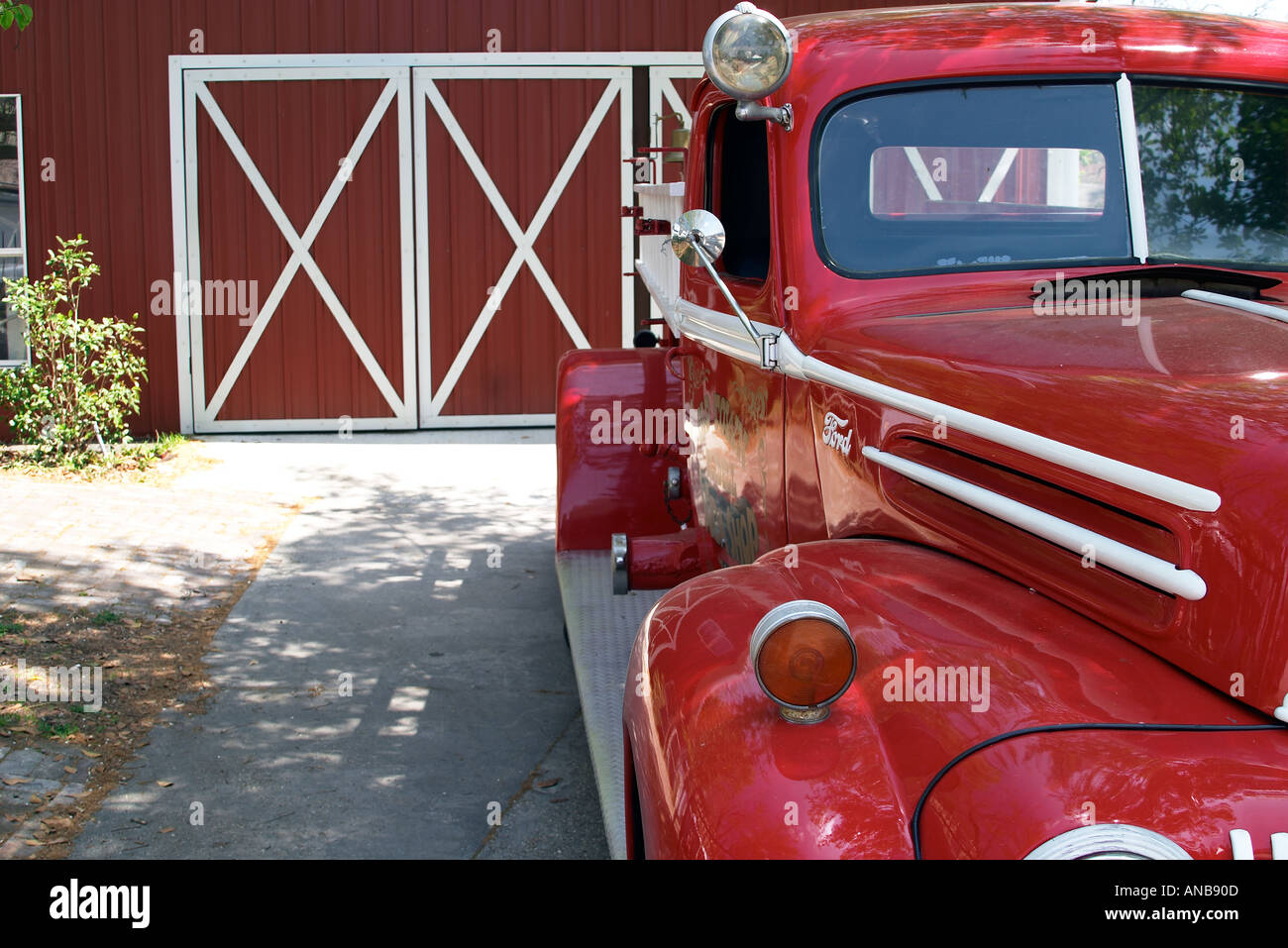 Antique fire engine in front of a red barn Stock Photo - Alamy