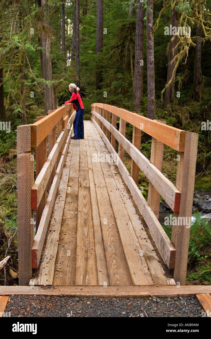 Woman crossing wooden bridge in Olympic national park Stock Photo - Alamy
