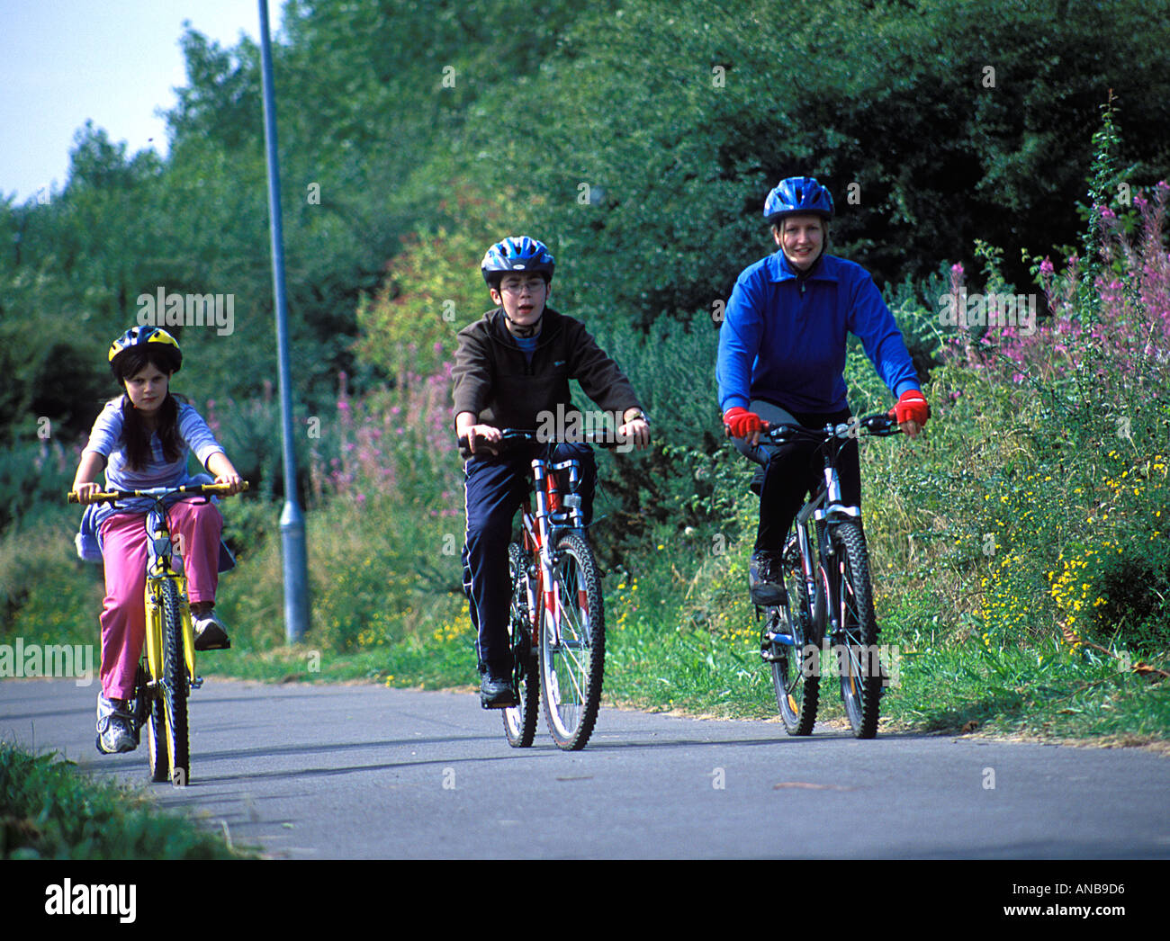 Mum son and daughter tentatively out on their first bike ride UK Stock ...