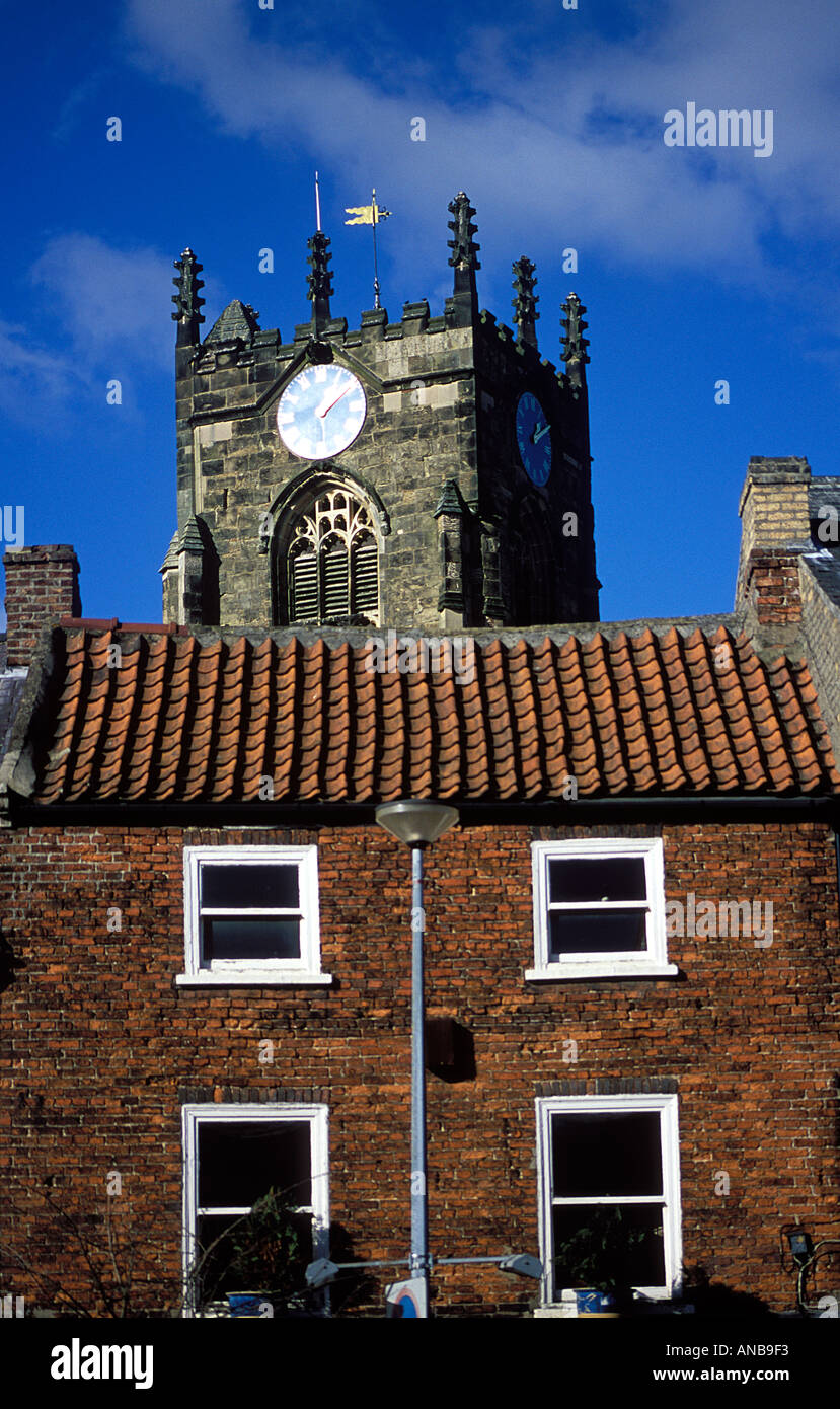 The Parish Church at Pocklington Yorkshire rises above the high street ...