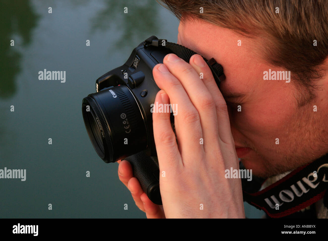 A man takes a picture with an dSLR camera Stock Photo - Alamy