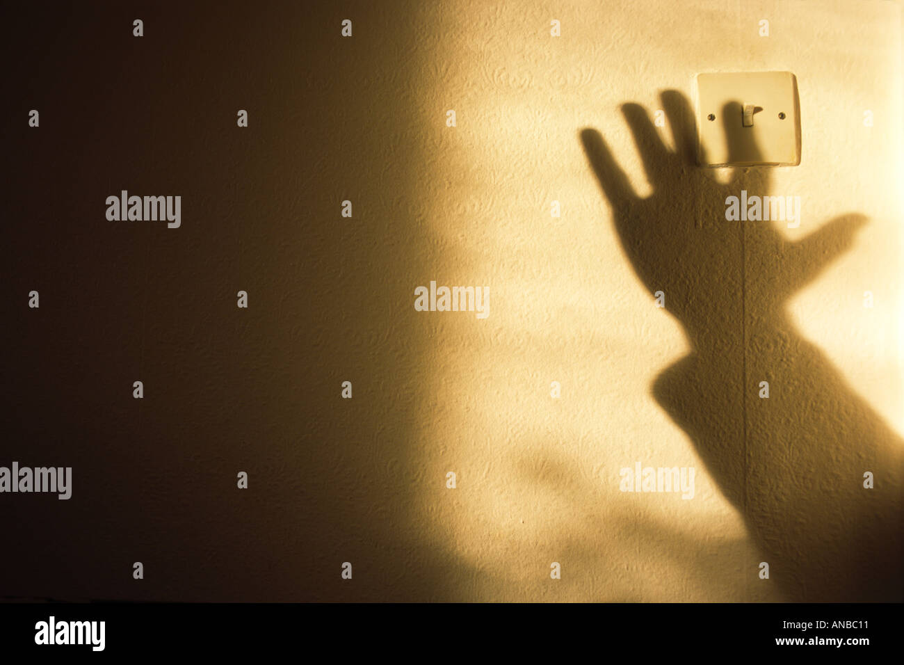 shadow hand on light switch Stock Photo - Alamy