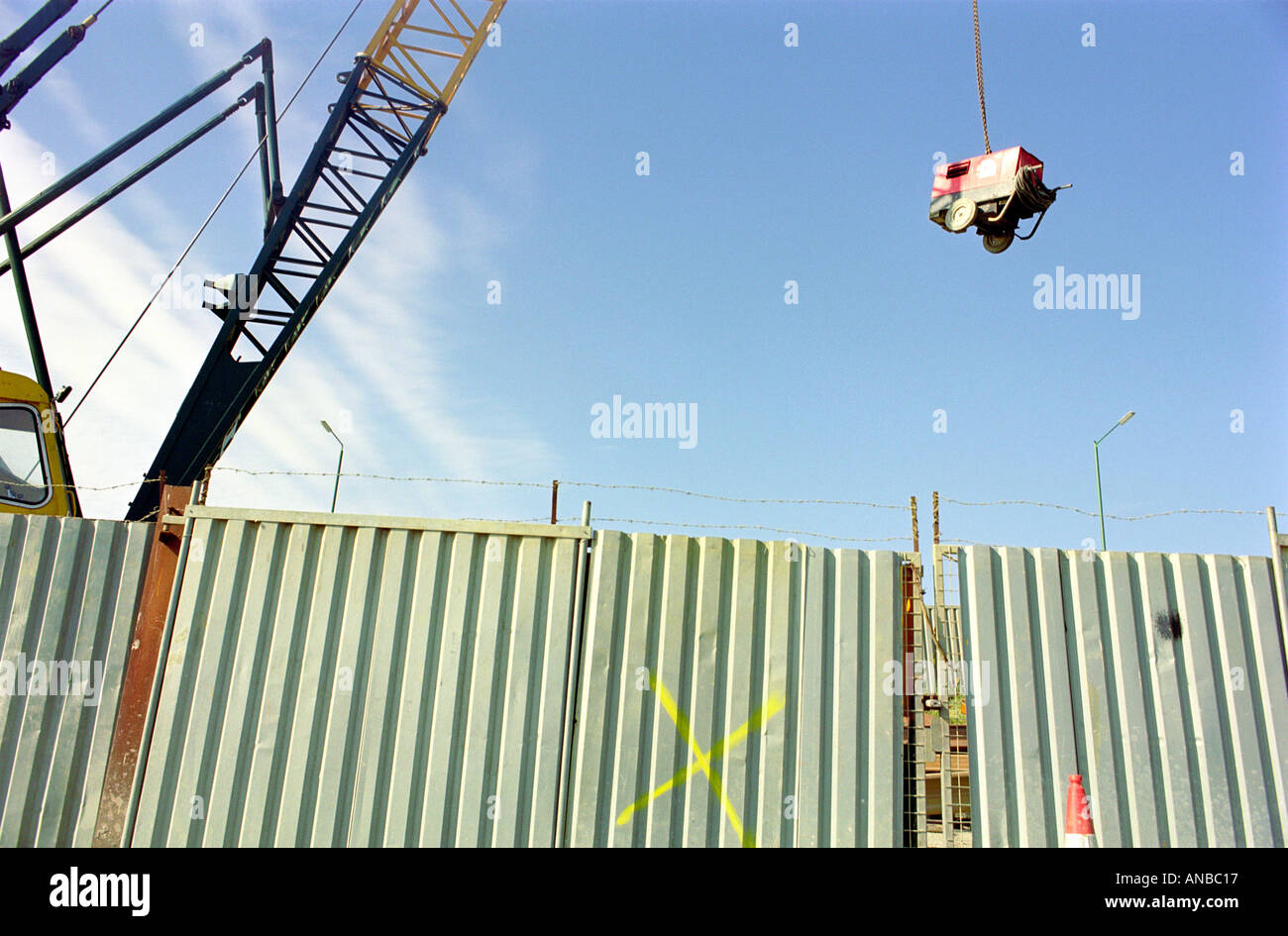 Machine suspended on building site Stock Photo - Alamy
