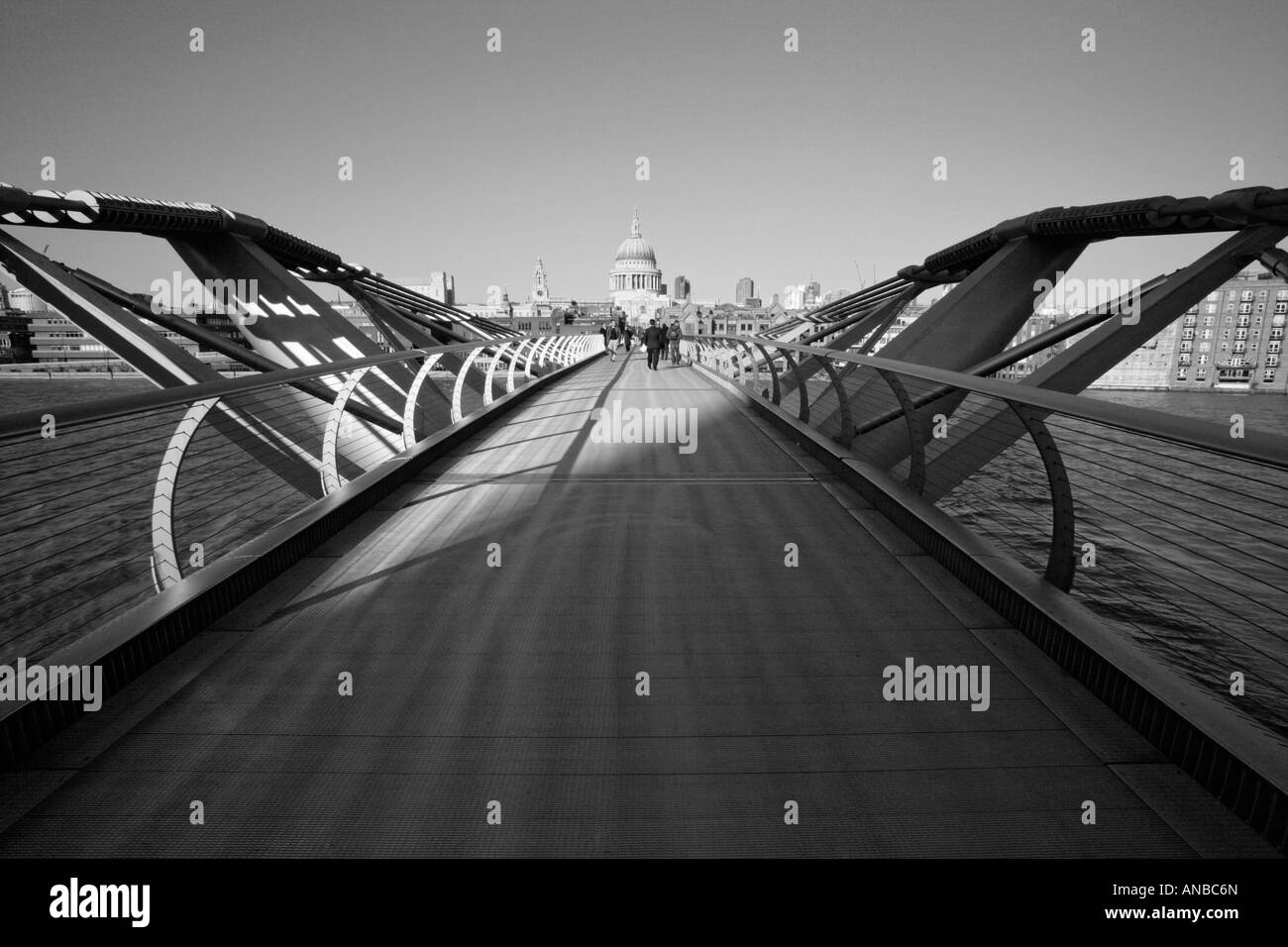 Millennium Bridge over the Thames in London UK with commuters walking ...