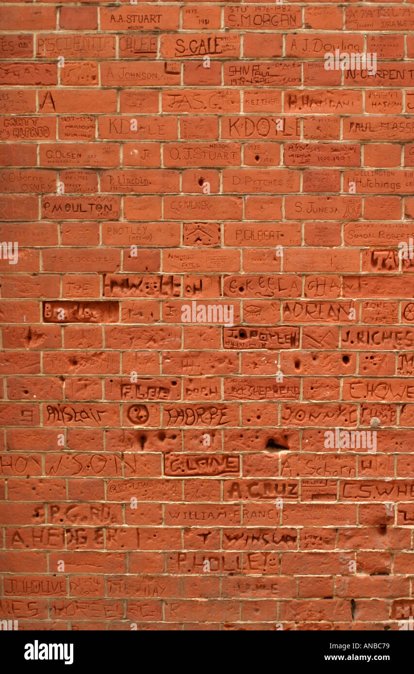 Names of schoolchildren scratched into red brick wall in school ...