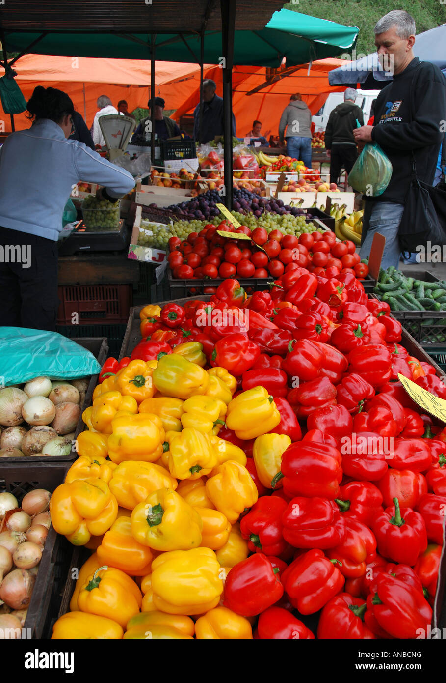 Vegetable market stall with red and yellow capsicum peppers Stock Photo ...